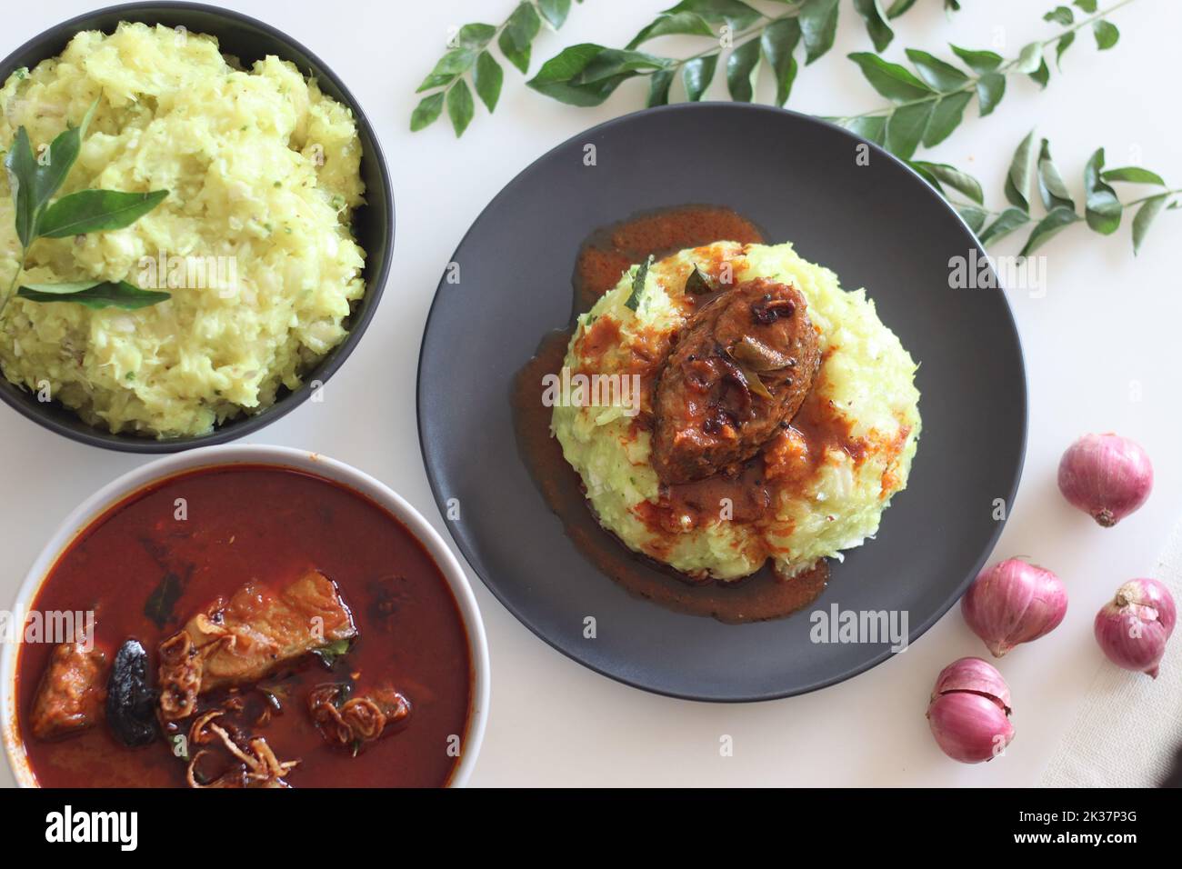 Mashed tapioca served with pomfret fish curry. Boiled and strained ...