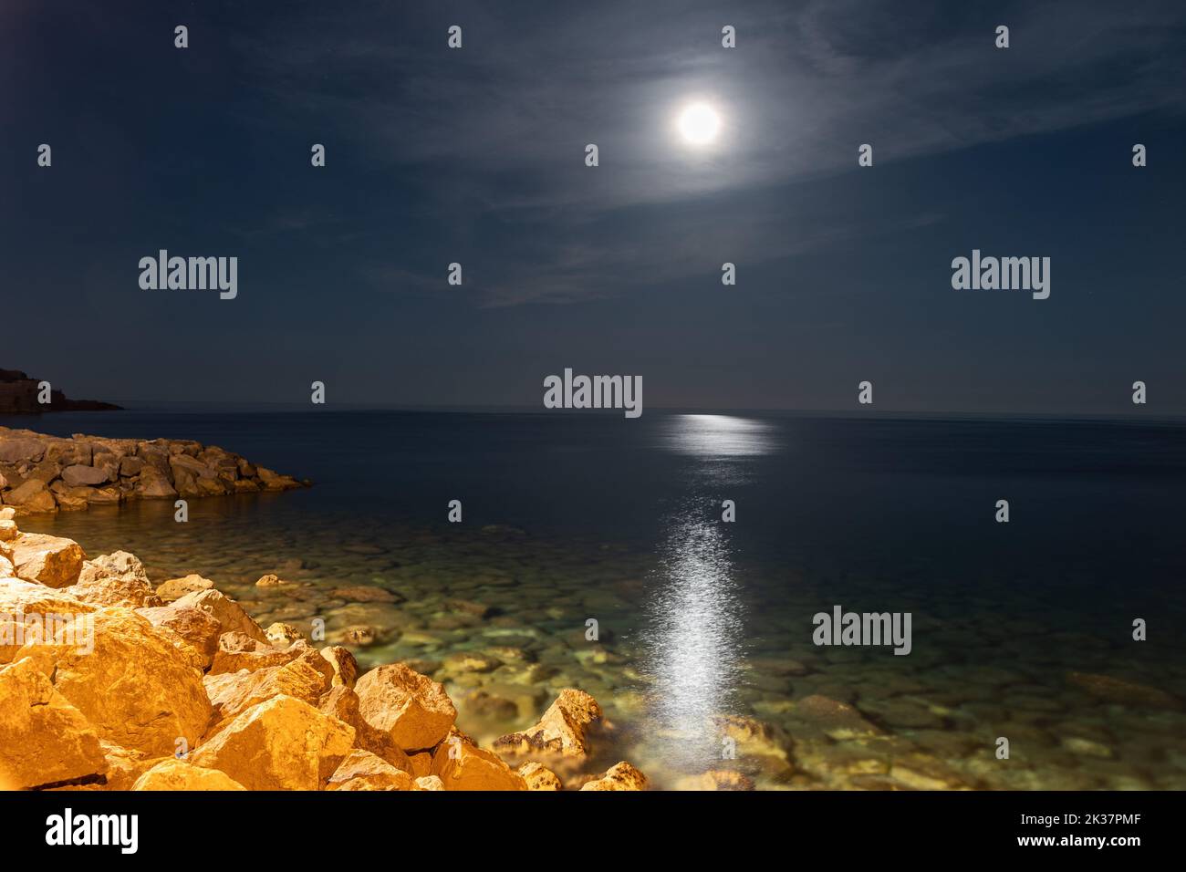 The night landscape of the beach and the beautiful moonlight reflecting ...