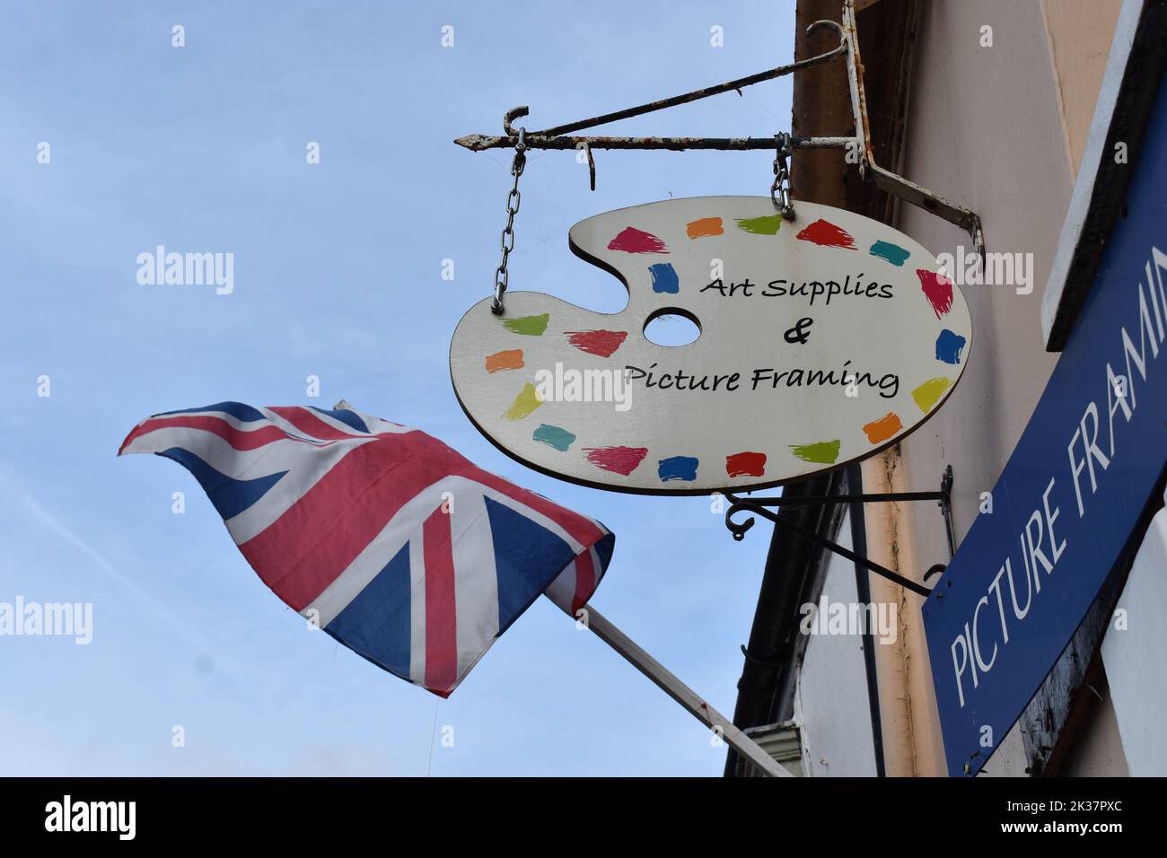 Quaint shop sign in the shape of an artist's palette Stock Photo - Alamy