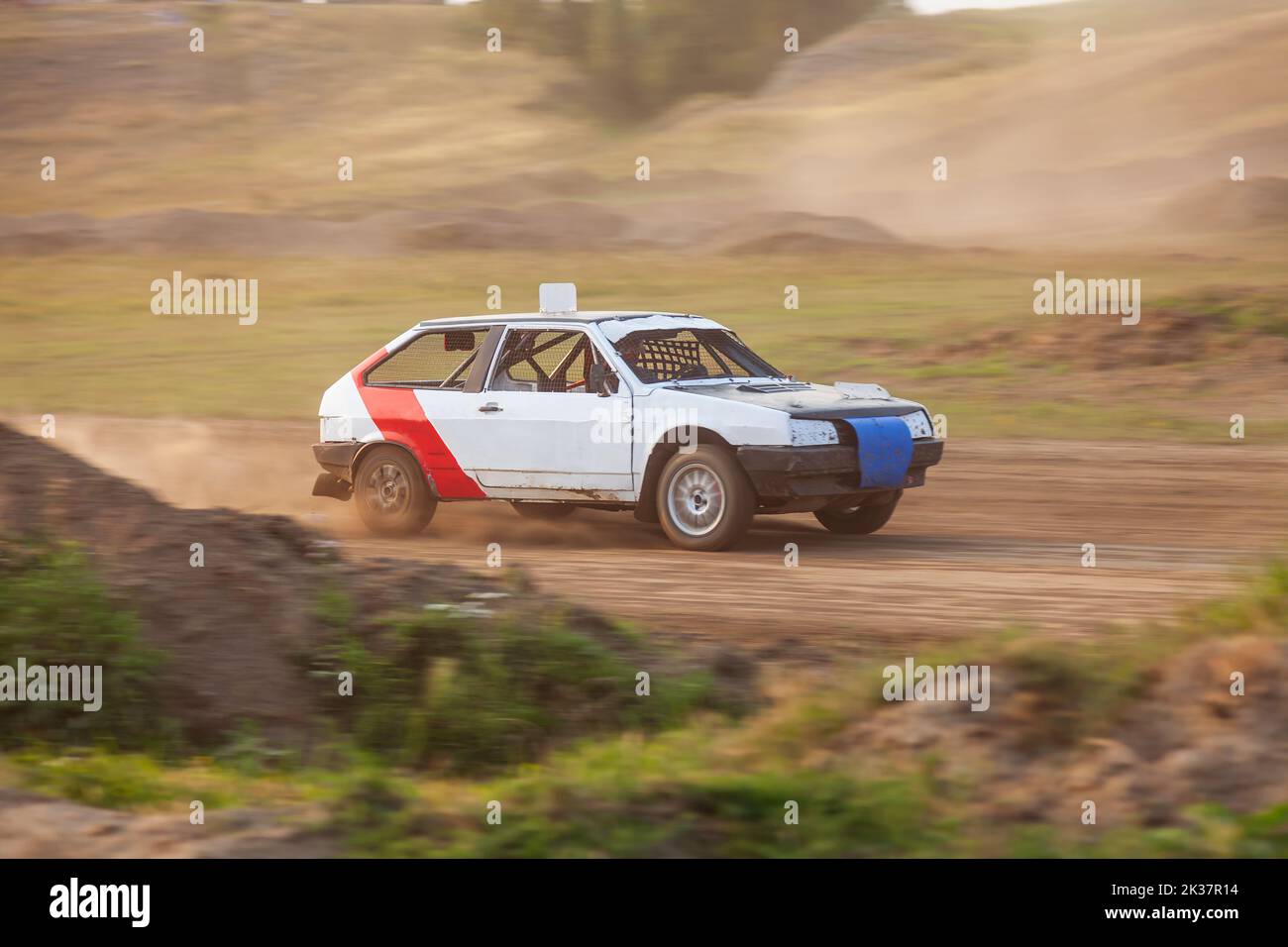 Rally off-road car make a turn with the clouds and splashes of sand ...