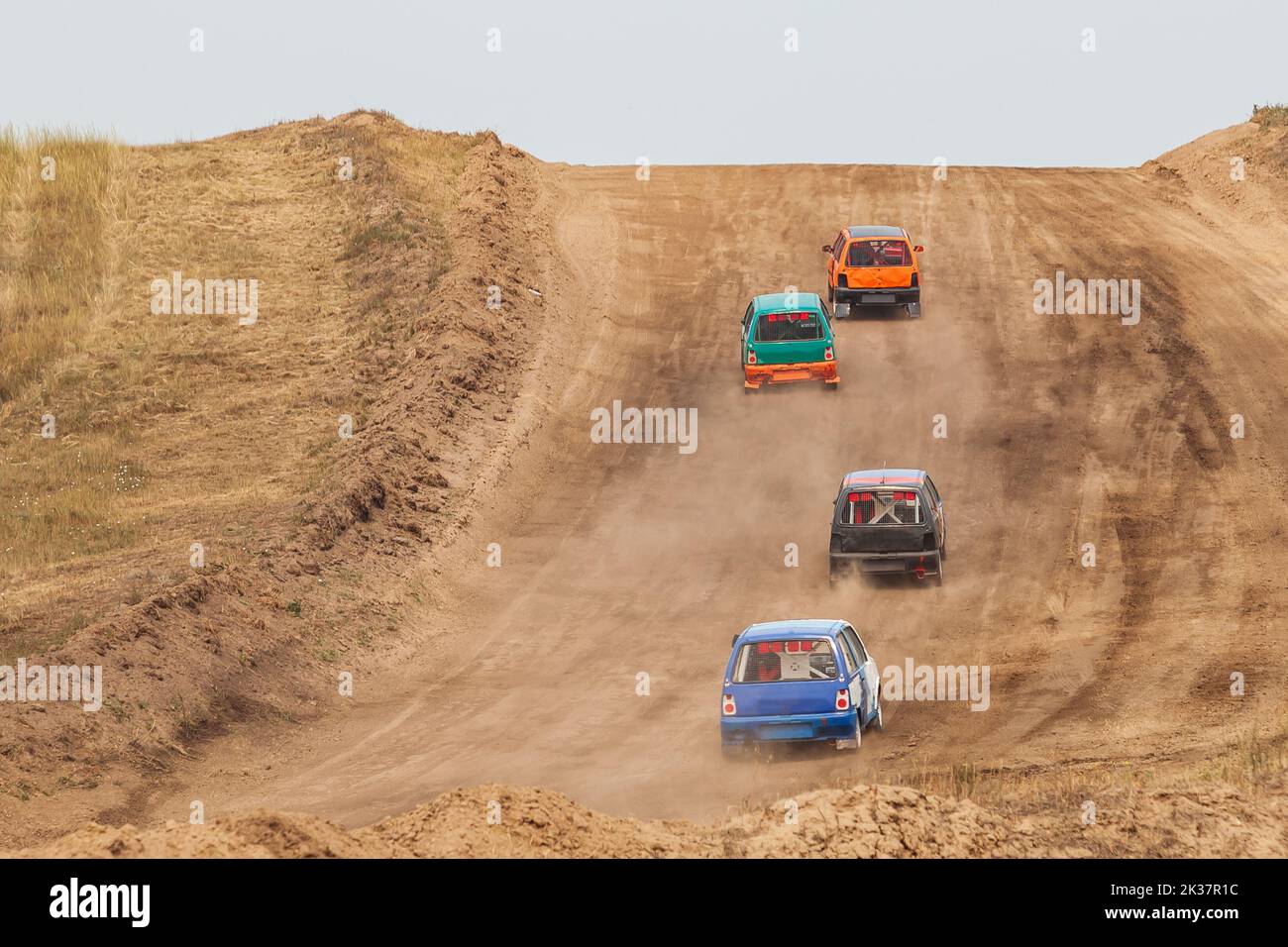 Rally off-road car make a turn with the clouds and splashes of sand ...