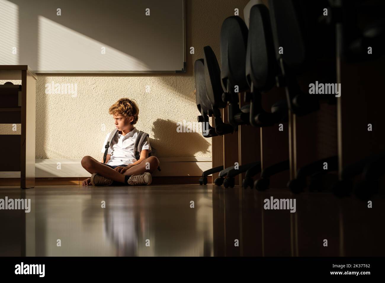 Schoolboy alone in classroom hi-res stock photography and images - Alamy