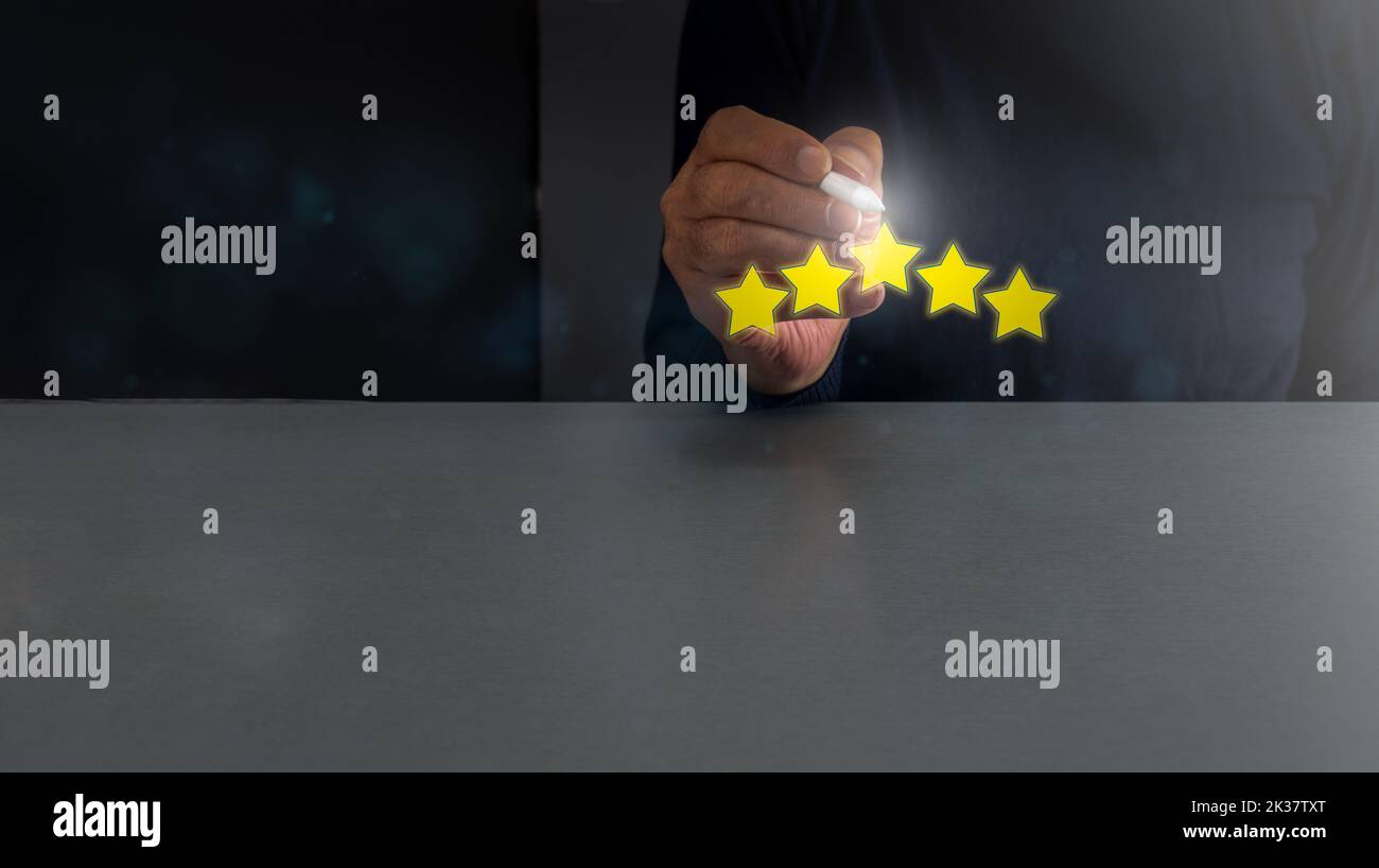 Businessman pointing to five star service rating symbol with white pen ... Businessman pointing to five star service rating symbol with white pen ...