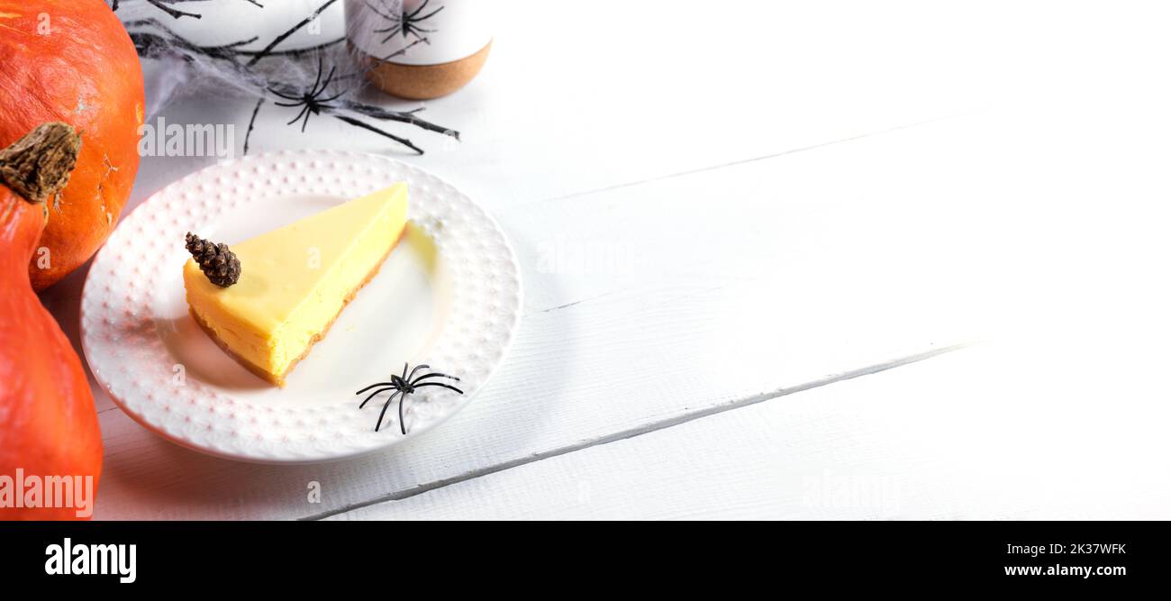 Pumpkin pie piece on white plate, orange pumpkins, black spiders on ...