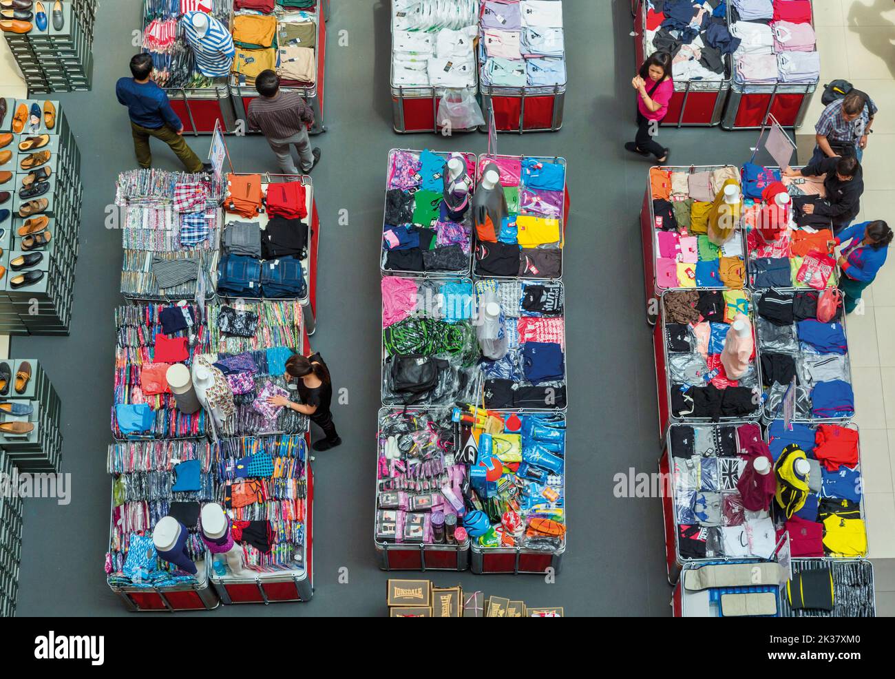 Customers checking through tables of clothing in one of the city's many ...
