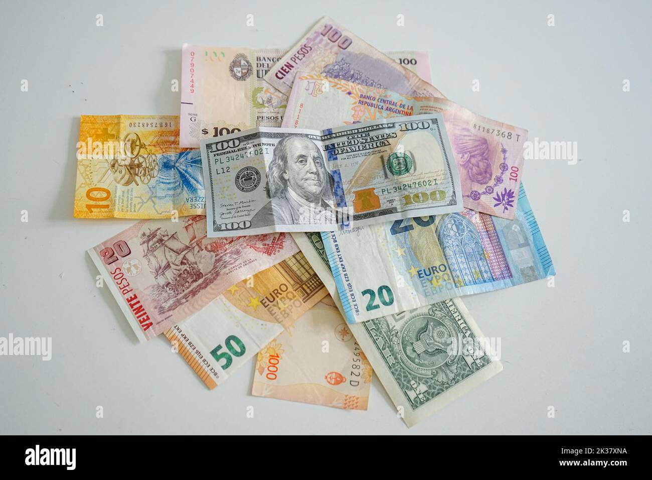 Banknotes from different currencies on white background Stock Photo - Alamy
