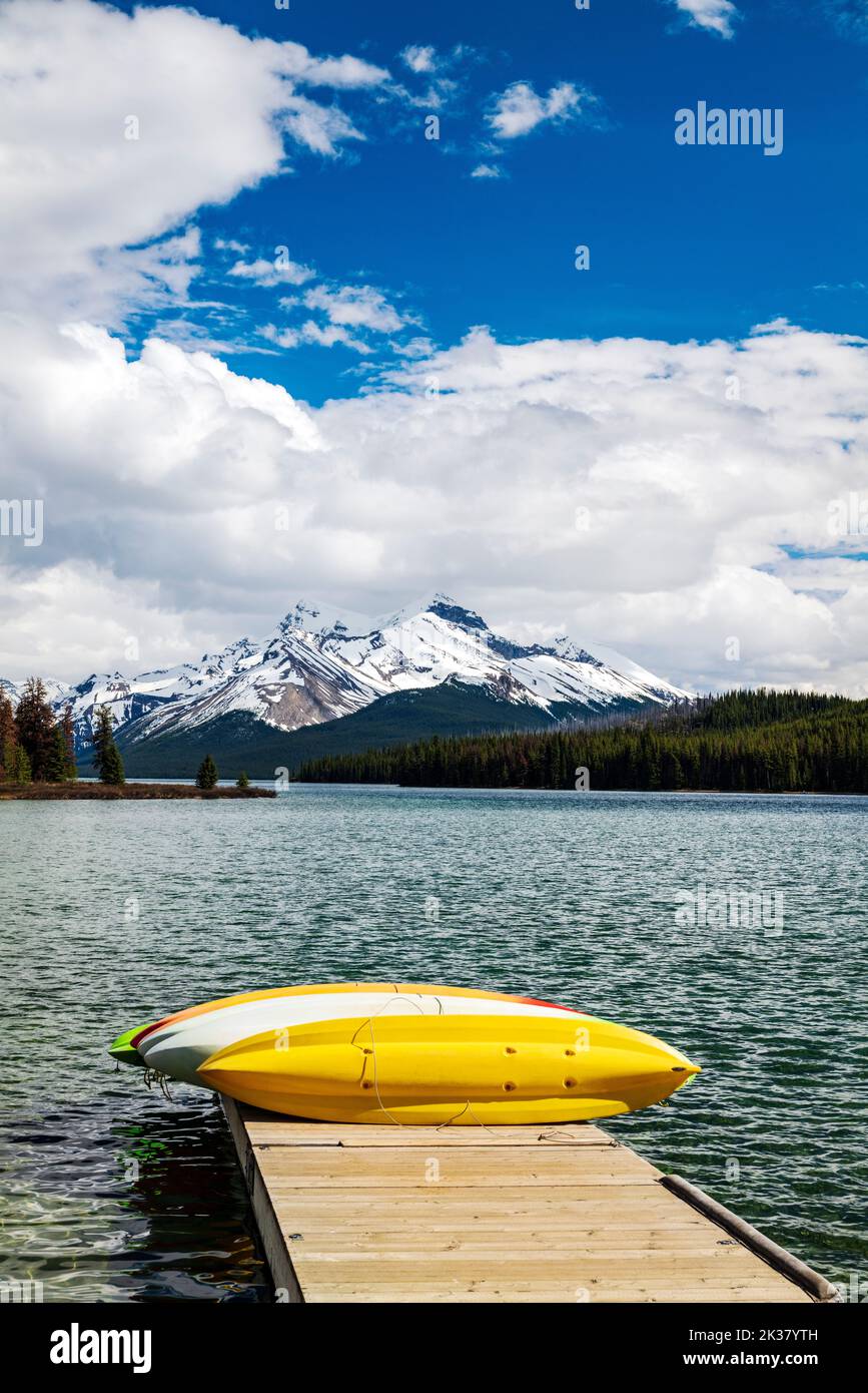 Colorful canoes on dock; Curly Phillips' Boat House; Maligne Lake ...