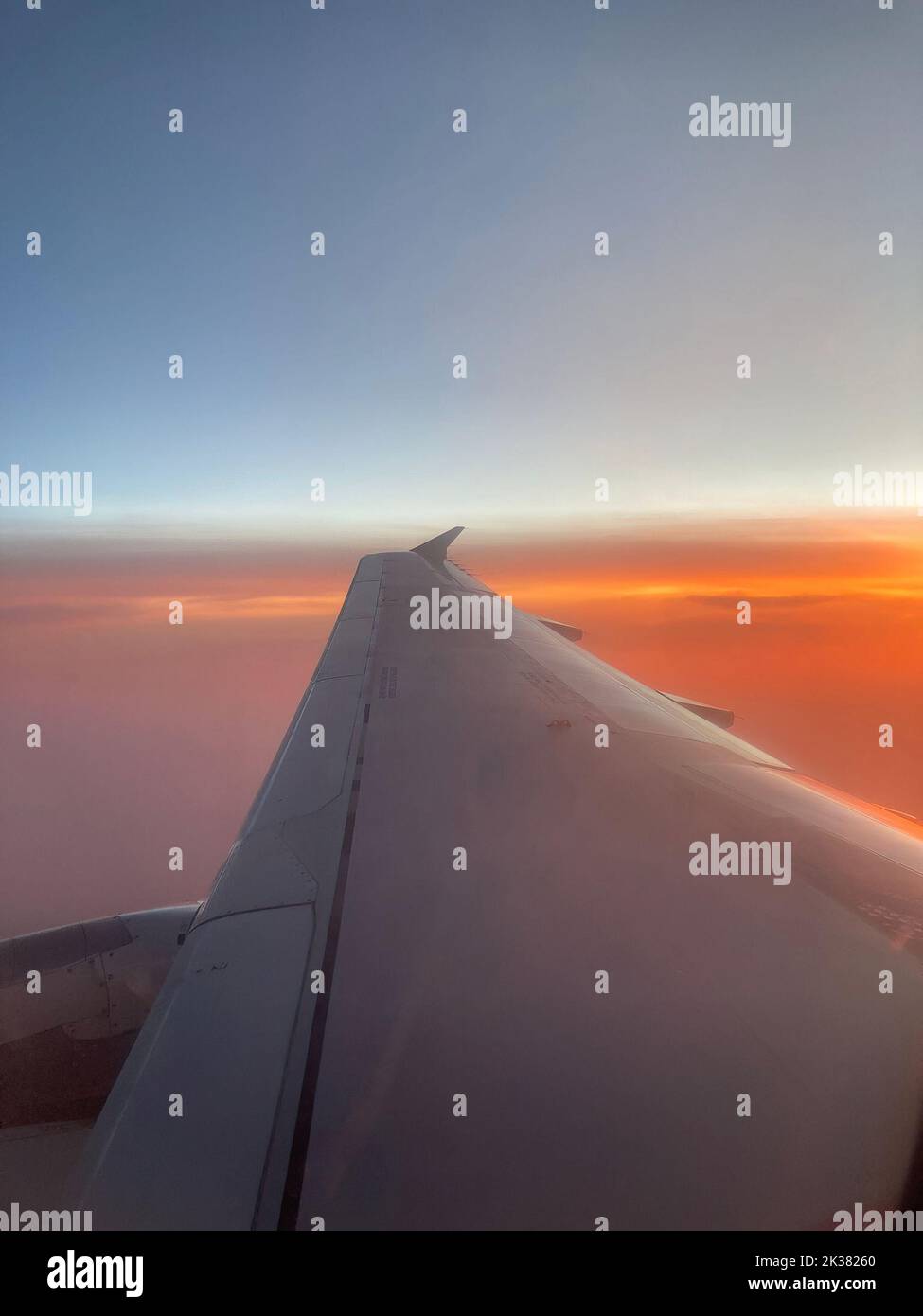A aerial view from airplane window of a sunset sky from onboard an ...