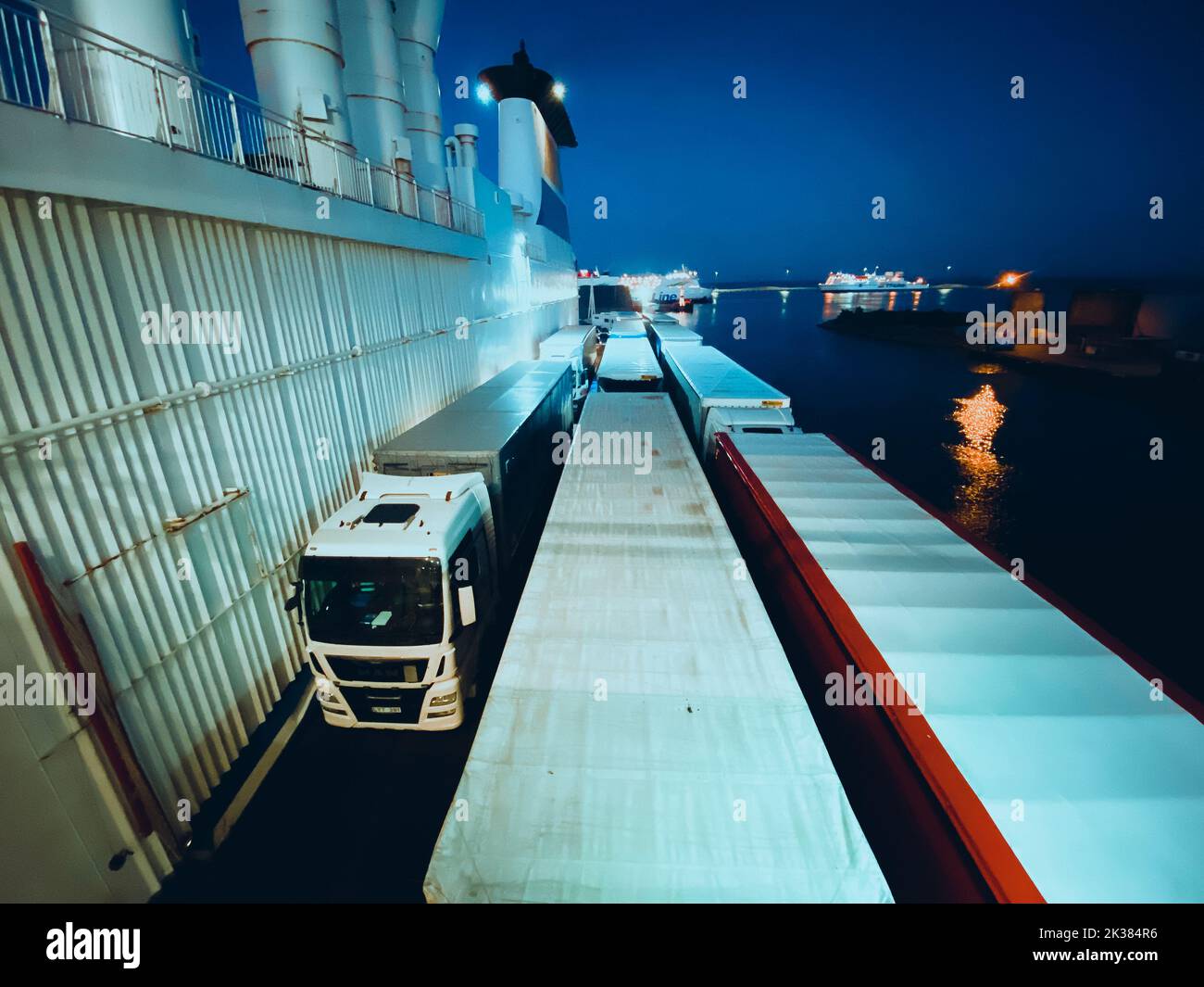 A row of parked lorries and truck trailers on a ferry boat in the port ...