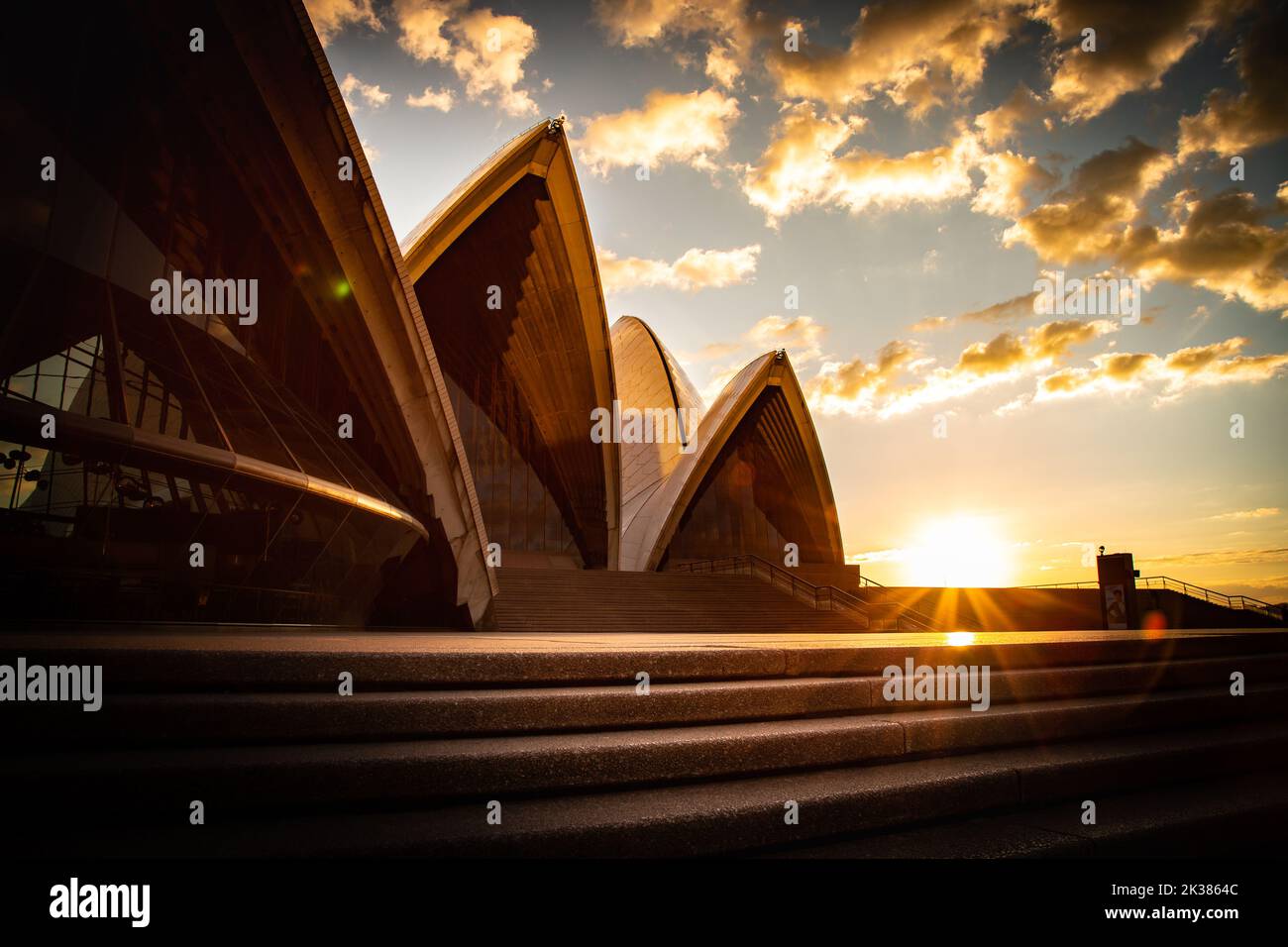 The famous Sydney Opera House in the warm light of sunrise with white ...