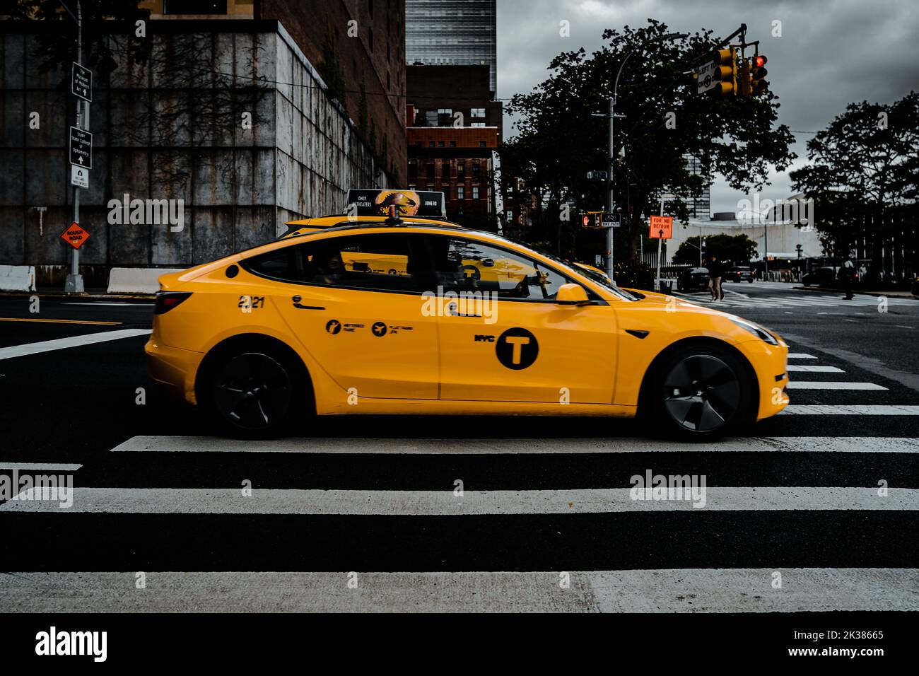 The view of yellow Tesla Taxi driving by with the New York urban ...