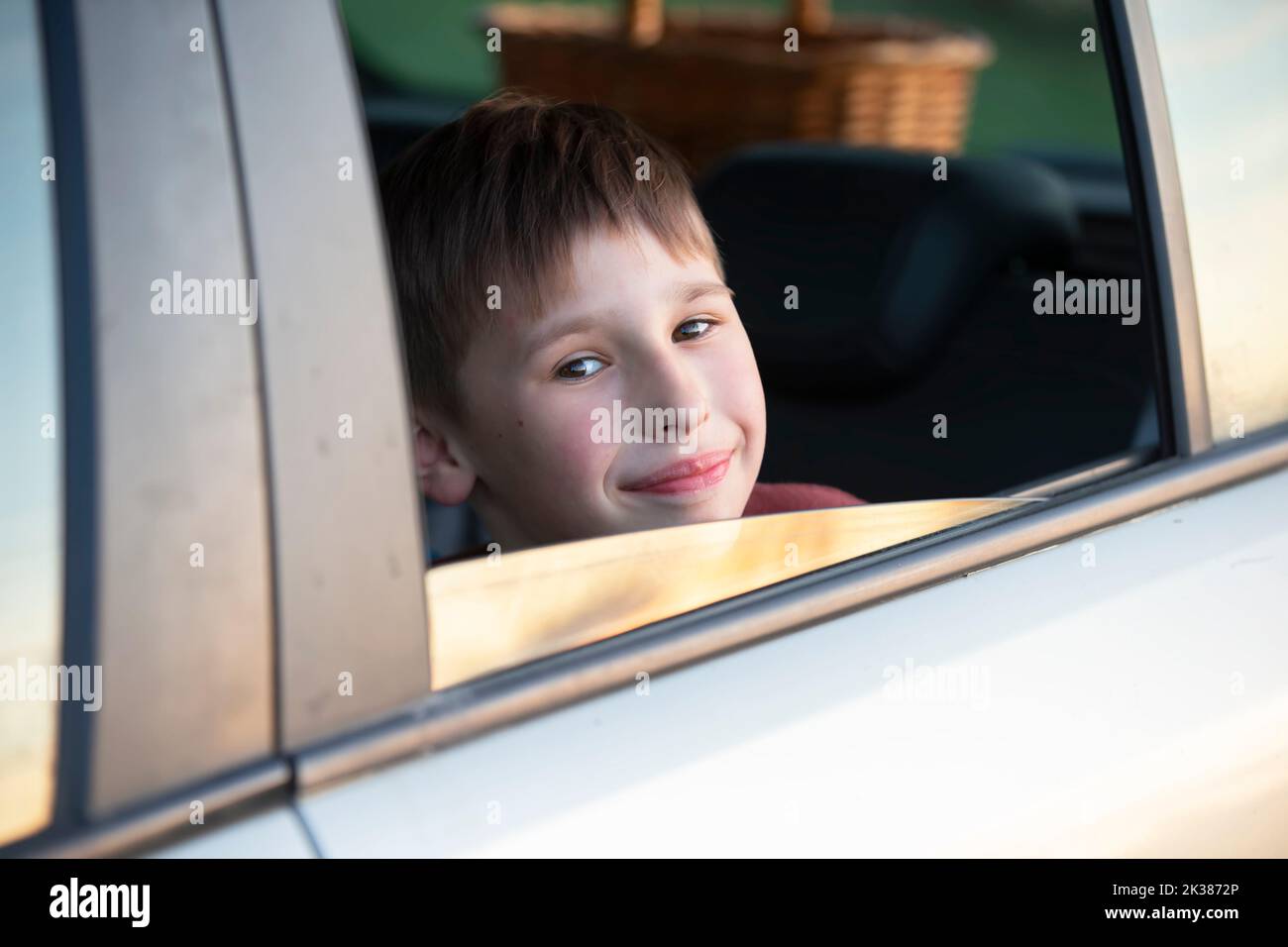 Child in the car. A little boy looks out of the car window Stock Photo ...