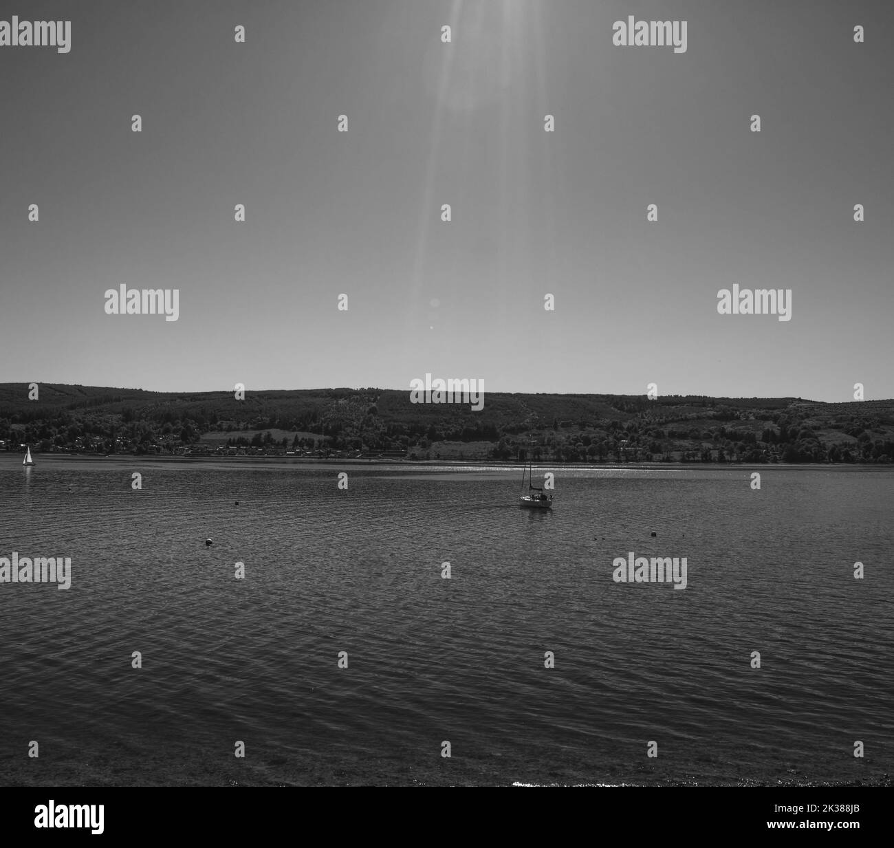 Landscape of Gare Loch with single sail boat during sunny day in summer ...