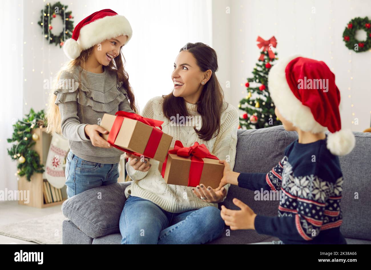 Happy joyful young mother gets unexpected presents from her loving ...