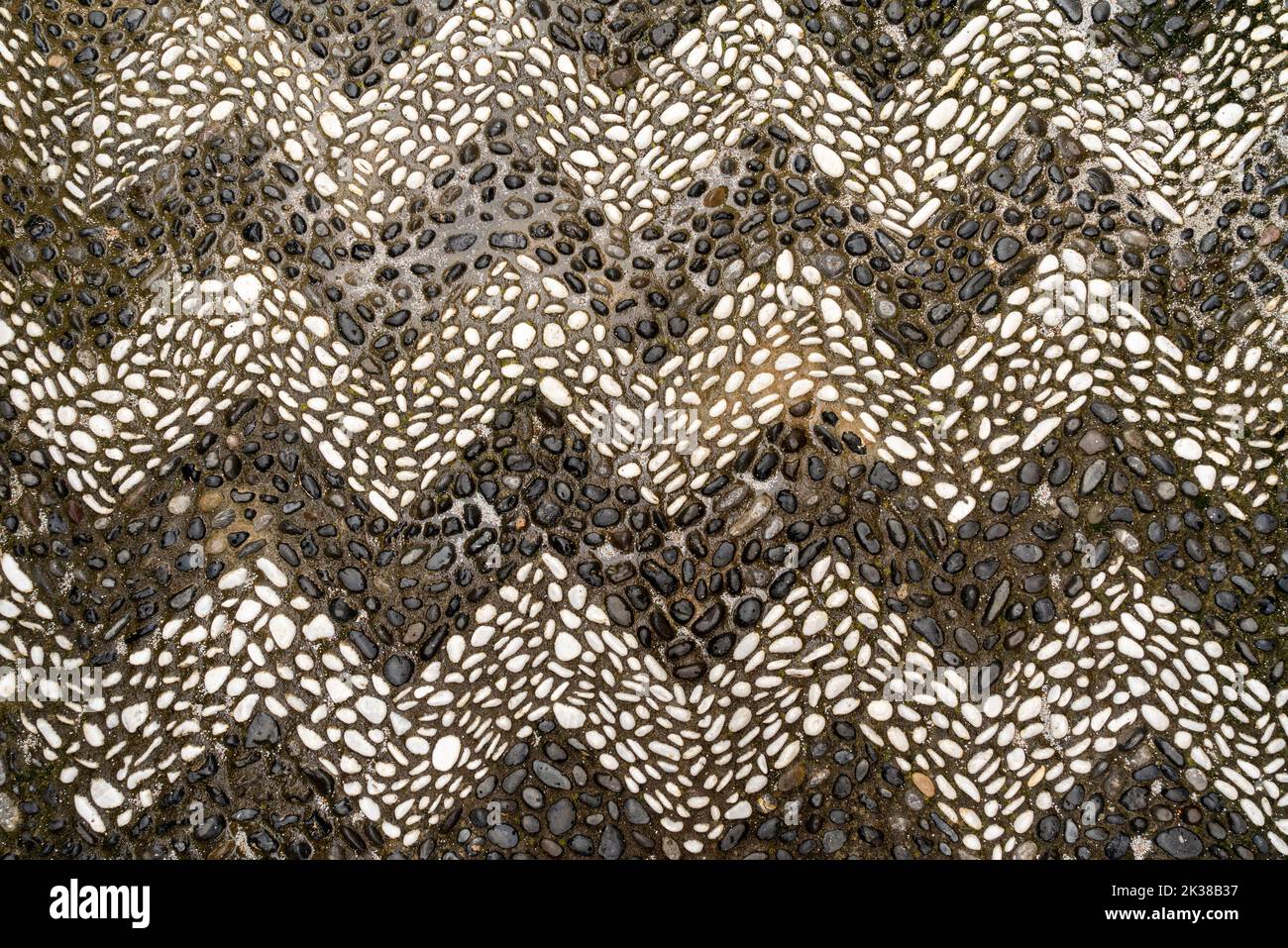 A black and white wavy pebble floor design on the island in Greece ...