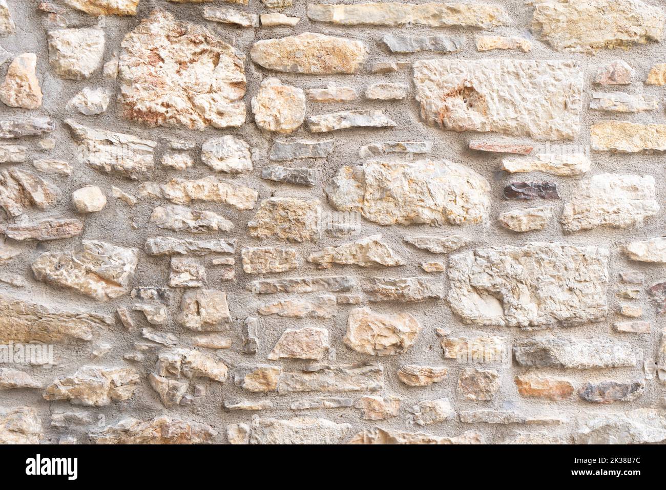 A rock wall texture background with stones of different shape and size ...