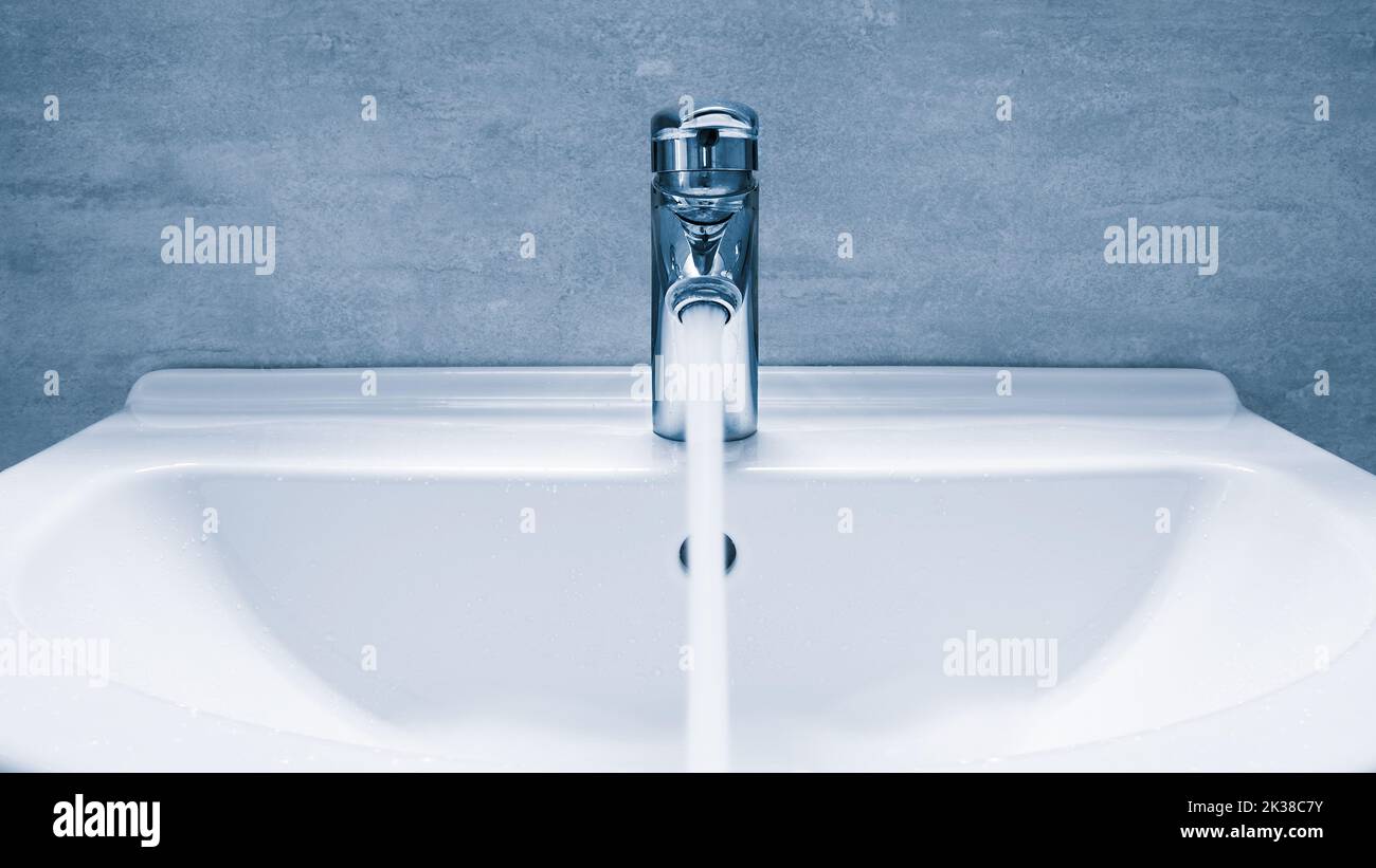 Bathroom water mixer. Water tap made of chrome material, Faucet with water in blue tone Stock ...