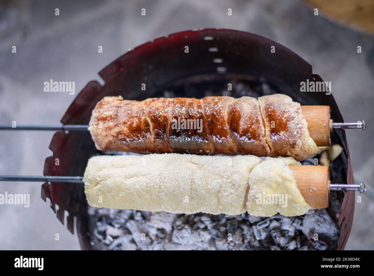 Chimney Cake baking on coal, coated in sugar Stock Photo - Alamy
