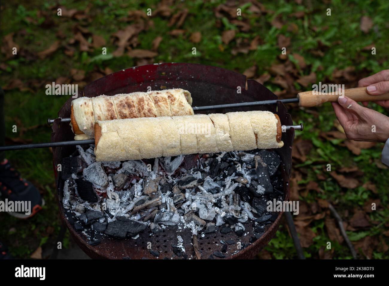 Chimney Cake baking on coal, coated in sugar Stock Photo - Alamy