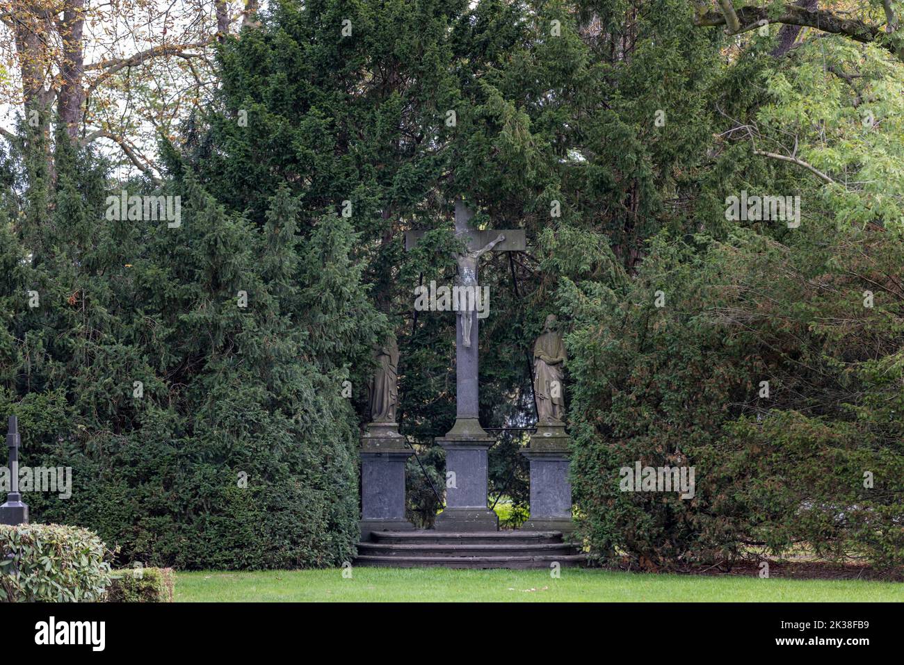 A statue of crucified Christ and two apostles in Cologne Stock Photo ...