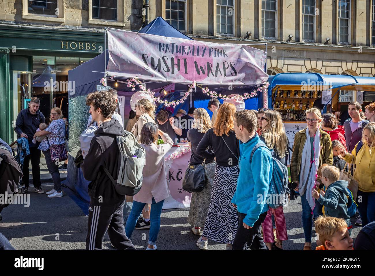 Colourful pink sushi wrap stall sign at the Great Bath Feast street ...
