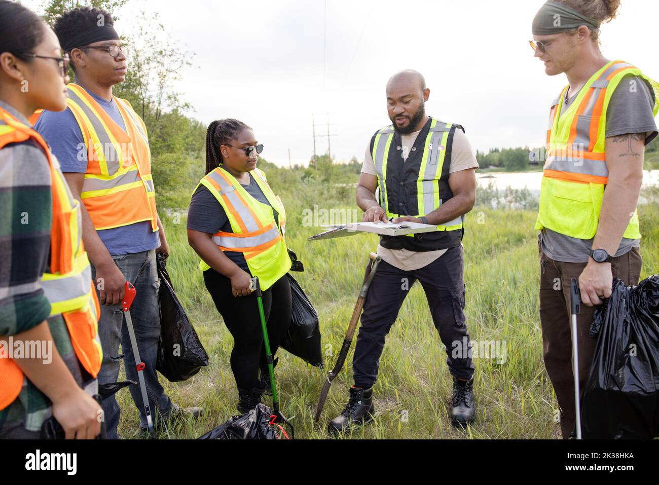 Man organizing litter picking volunteers Stock Photo - Alamy