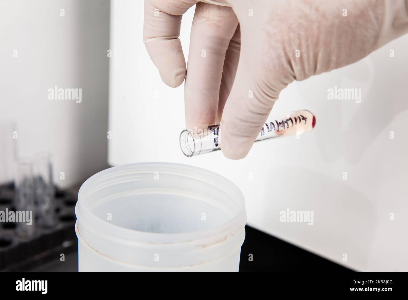 Scientist discarding the supernatant after centrifugation. Scientist ...