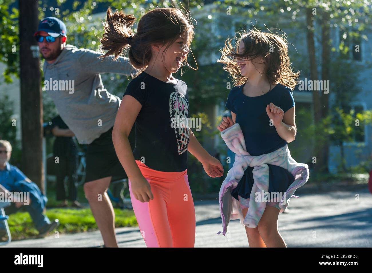 Two young girls dancing at the West Concord Porchfest, an annual ...
