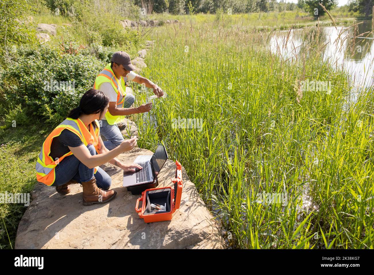 Environmental inspectors checking water quality in lake Stock Photo - Alamy