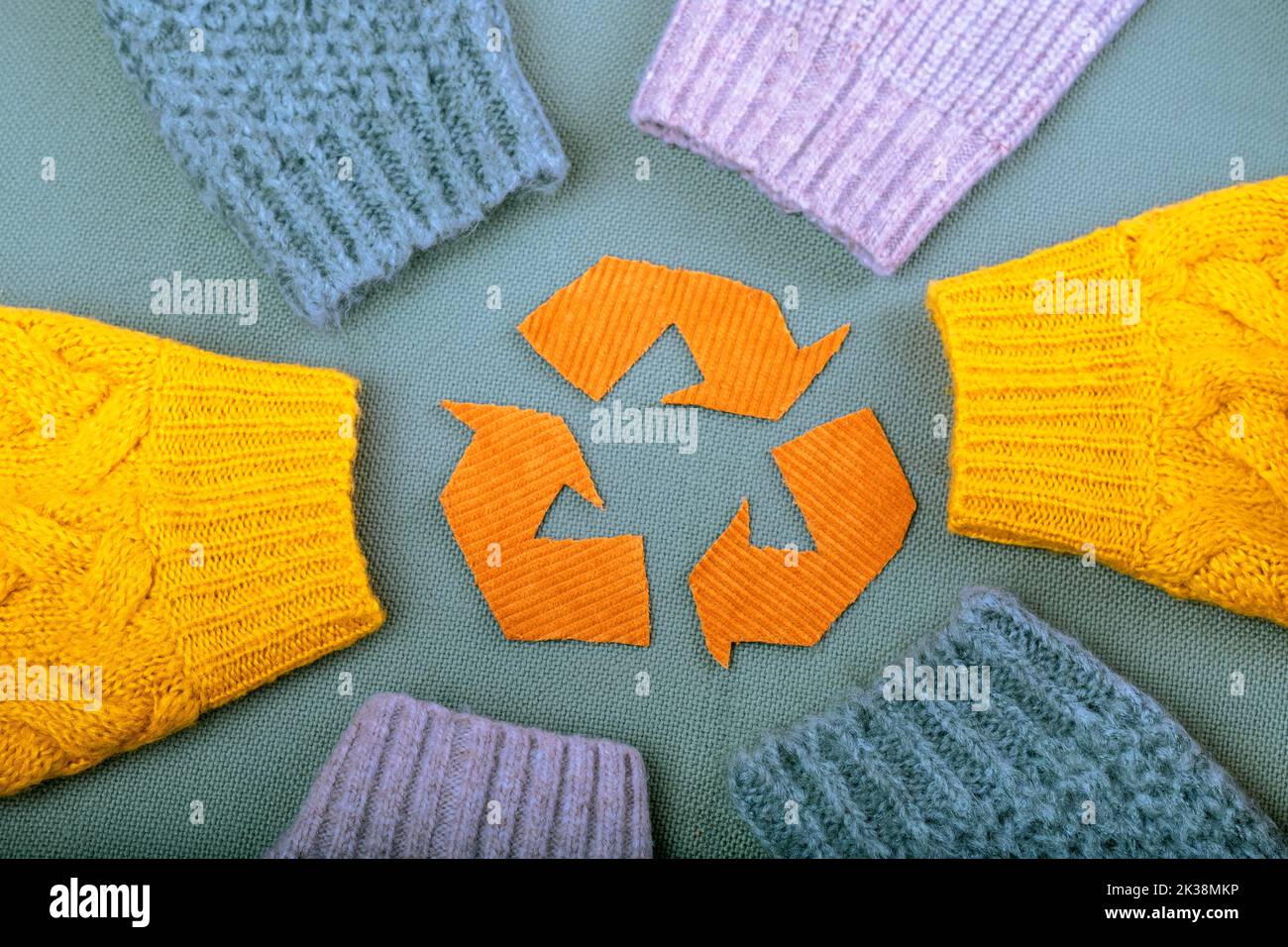 Recycling of clothes. Used clothes. Sleeves of knitted sweaters on a ...
