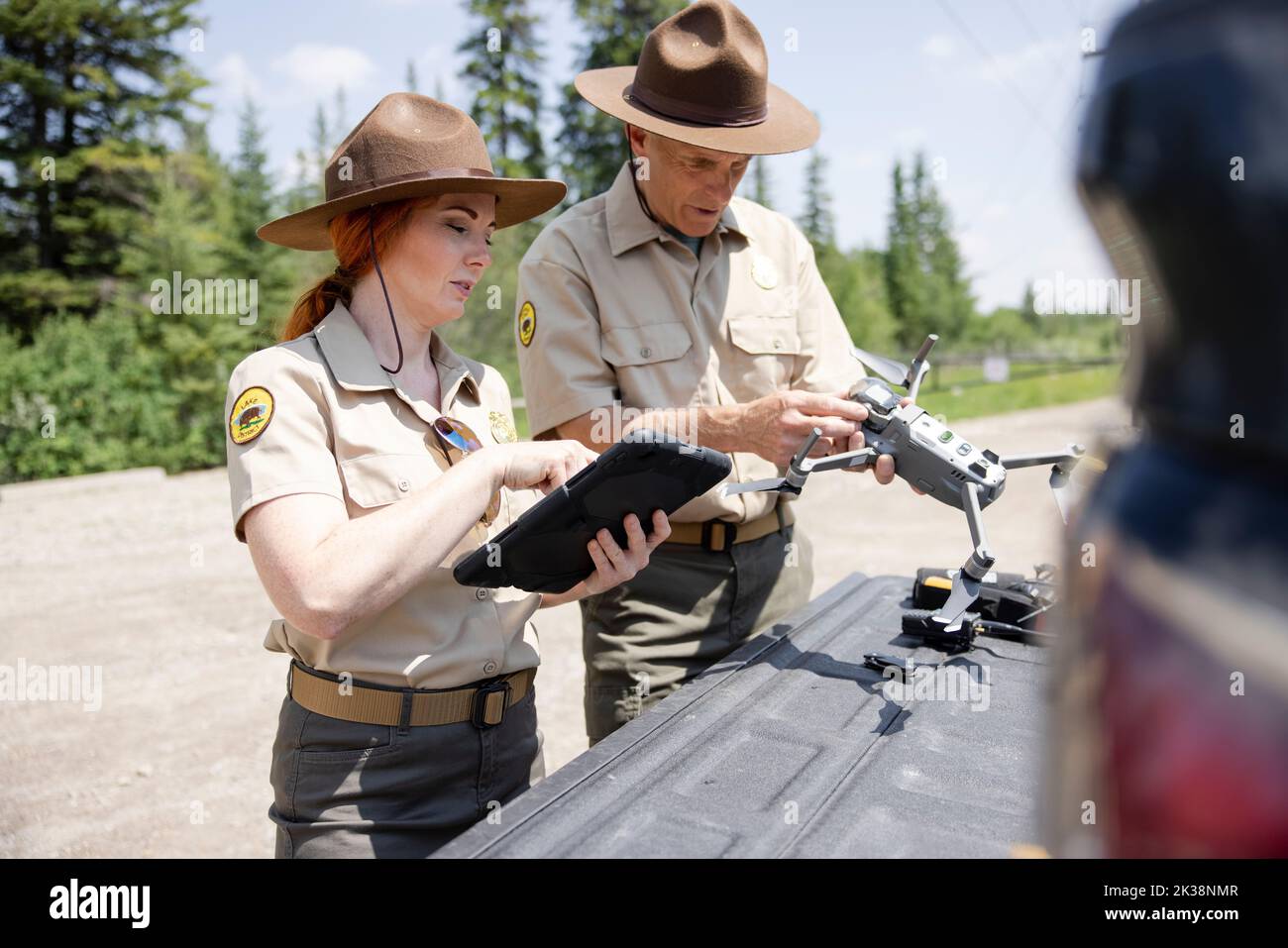 Ranger setting up drone with tablet Stock Photo - Alamy