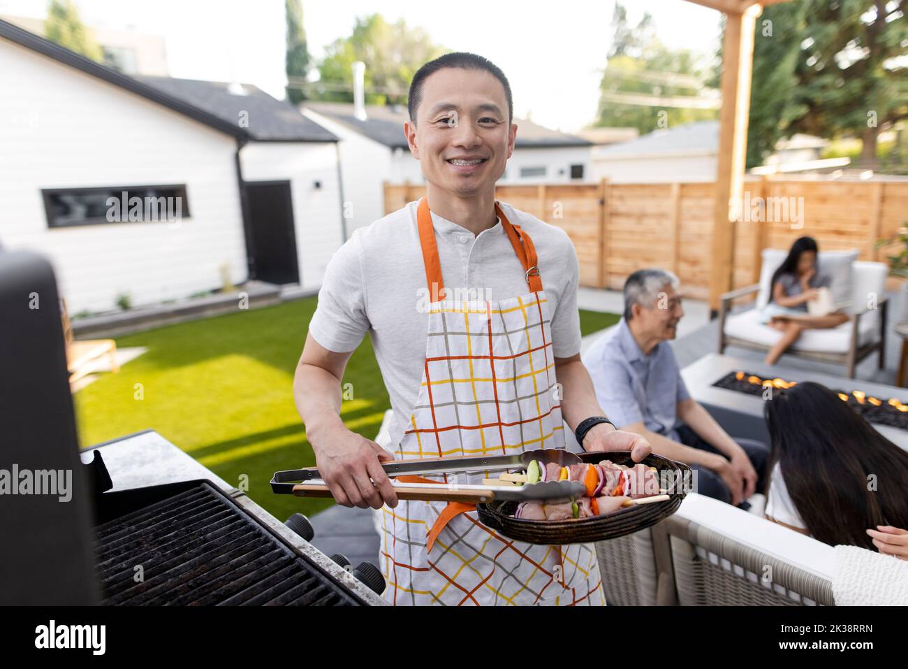 Black man cooking on a barbecue hi-res stock photography and images - Alamy