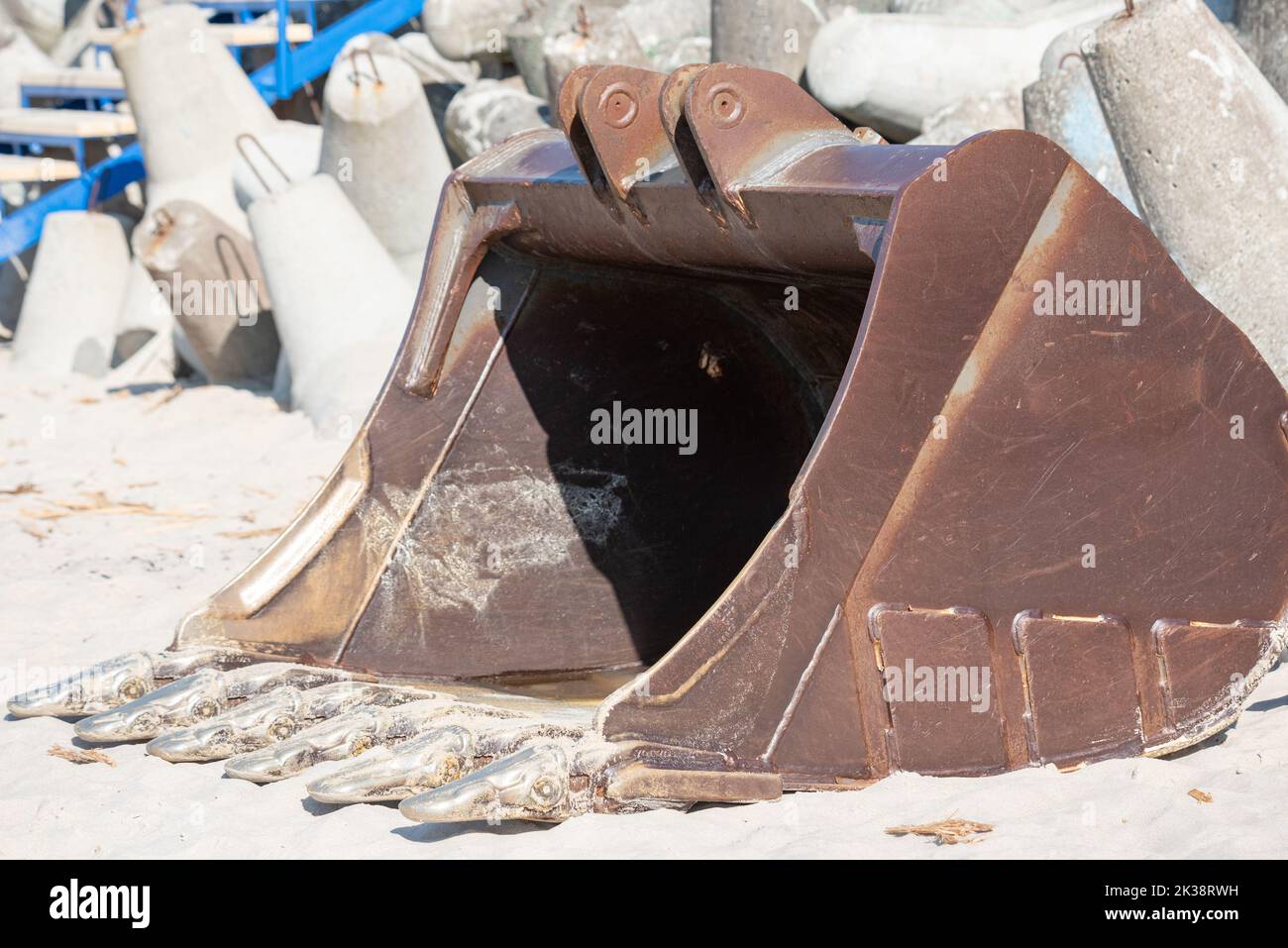 Excavator bucket on sand. Construction equipment on the beach. Heavy ...