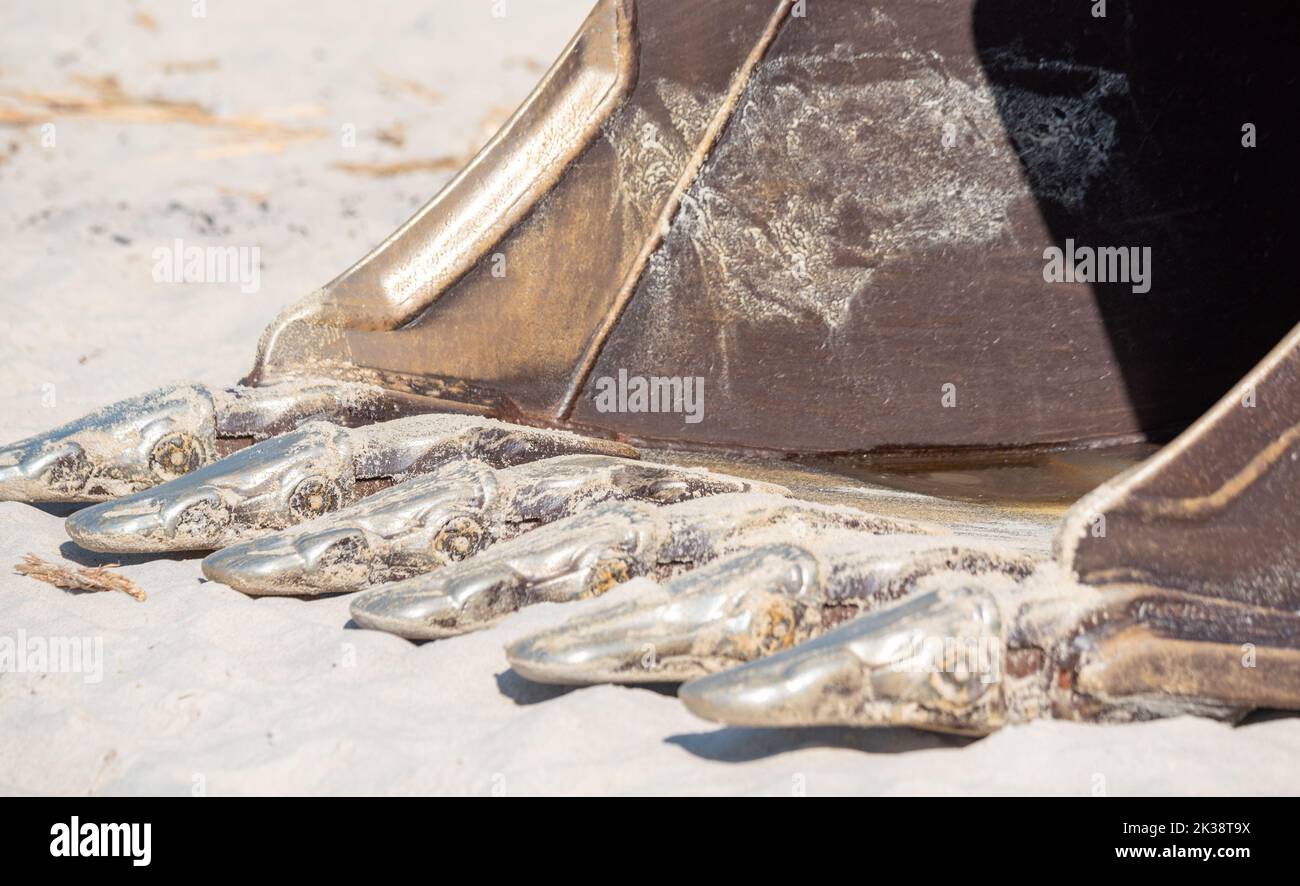 Excavator bucket on sand. Construction equipment on the beach. Heavy ...