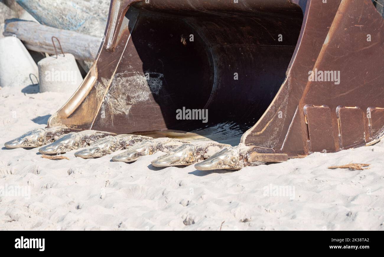 Excavator bucket on sand. Construction equipment on the beach. Heavy ...