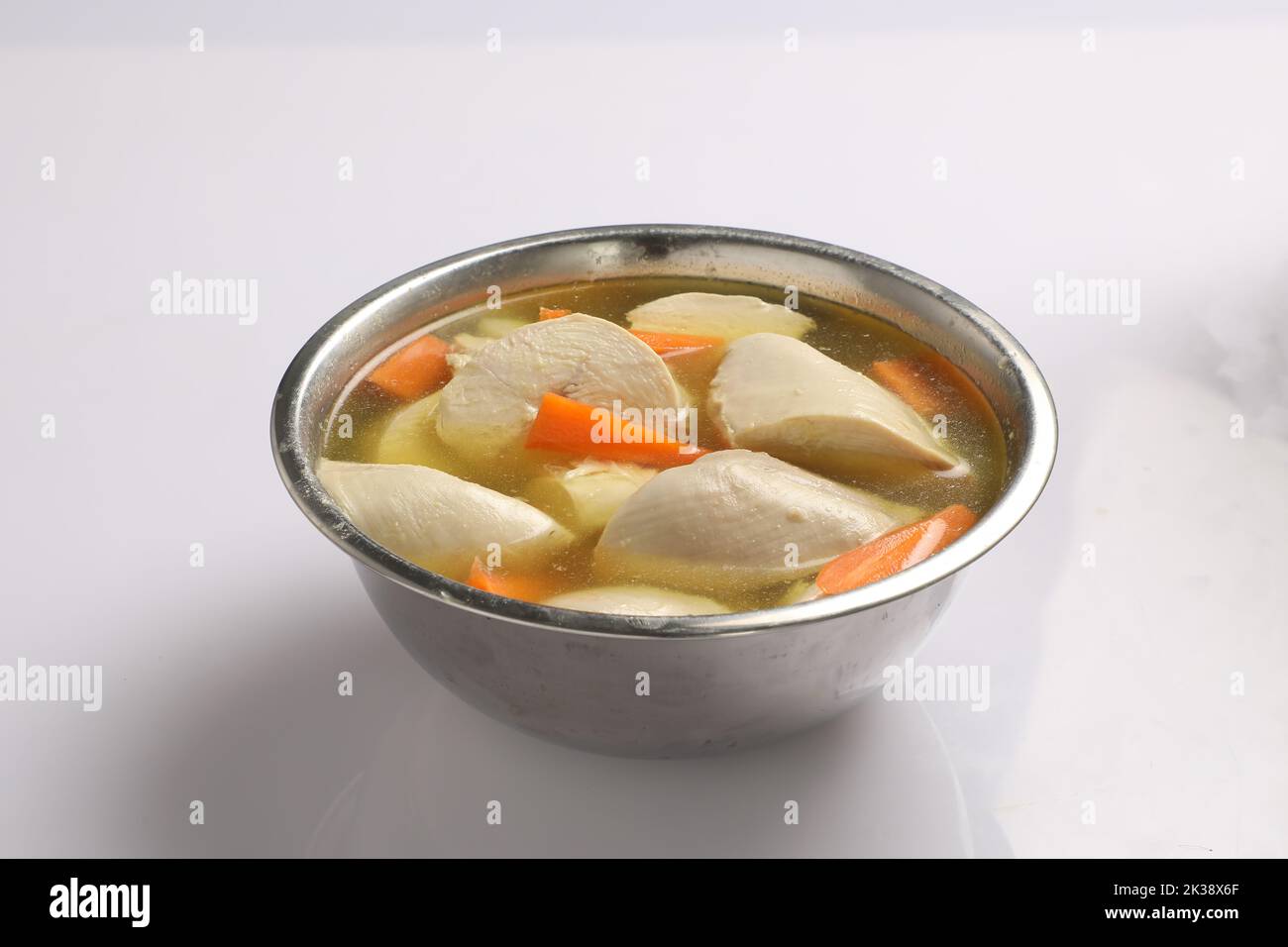 Clear Chicken broth with pieces of under the water tap. Chicken Soap ...