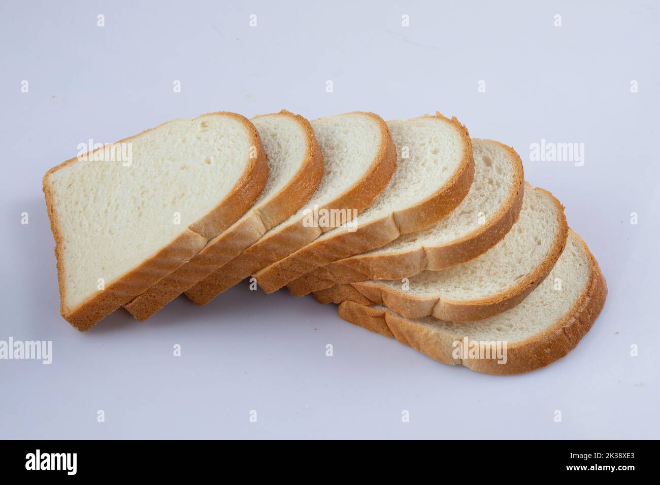 whole wheat bread slices on a white background Stock Photo - Alamy