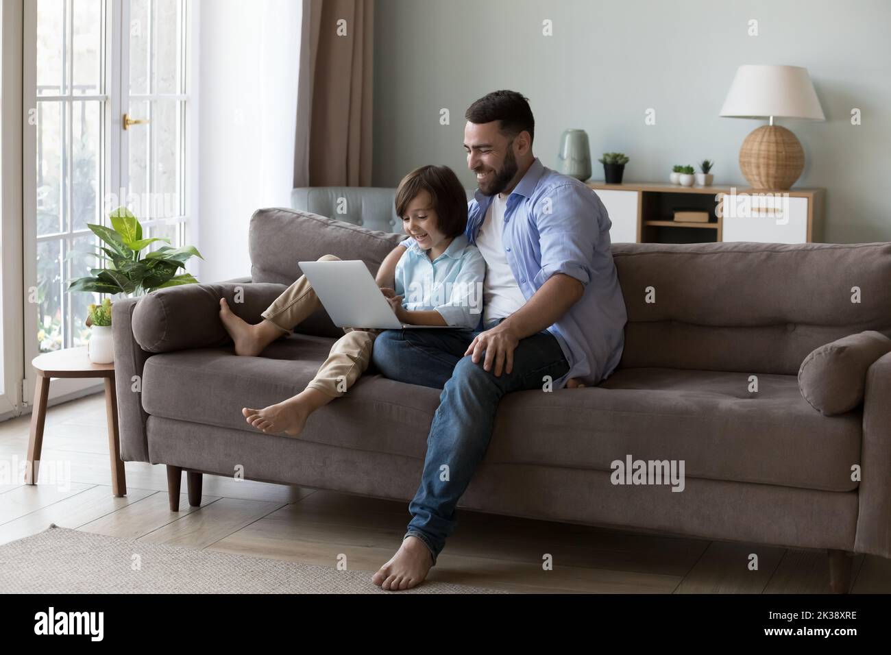 Happy millennial father hugging curious gen Z son kid Stock Photo - Alamy
