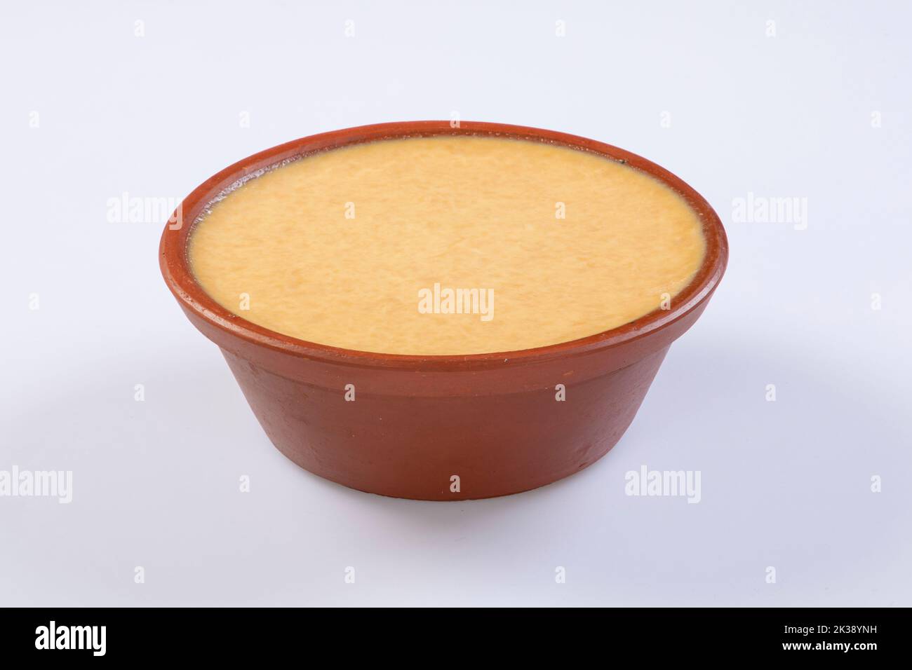 delicious misti doi is a Bengali dessert in a mud pot isolated on white ...