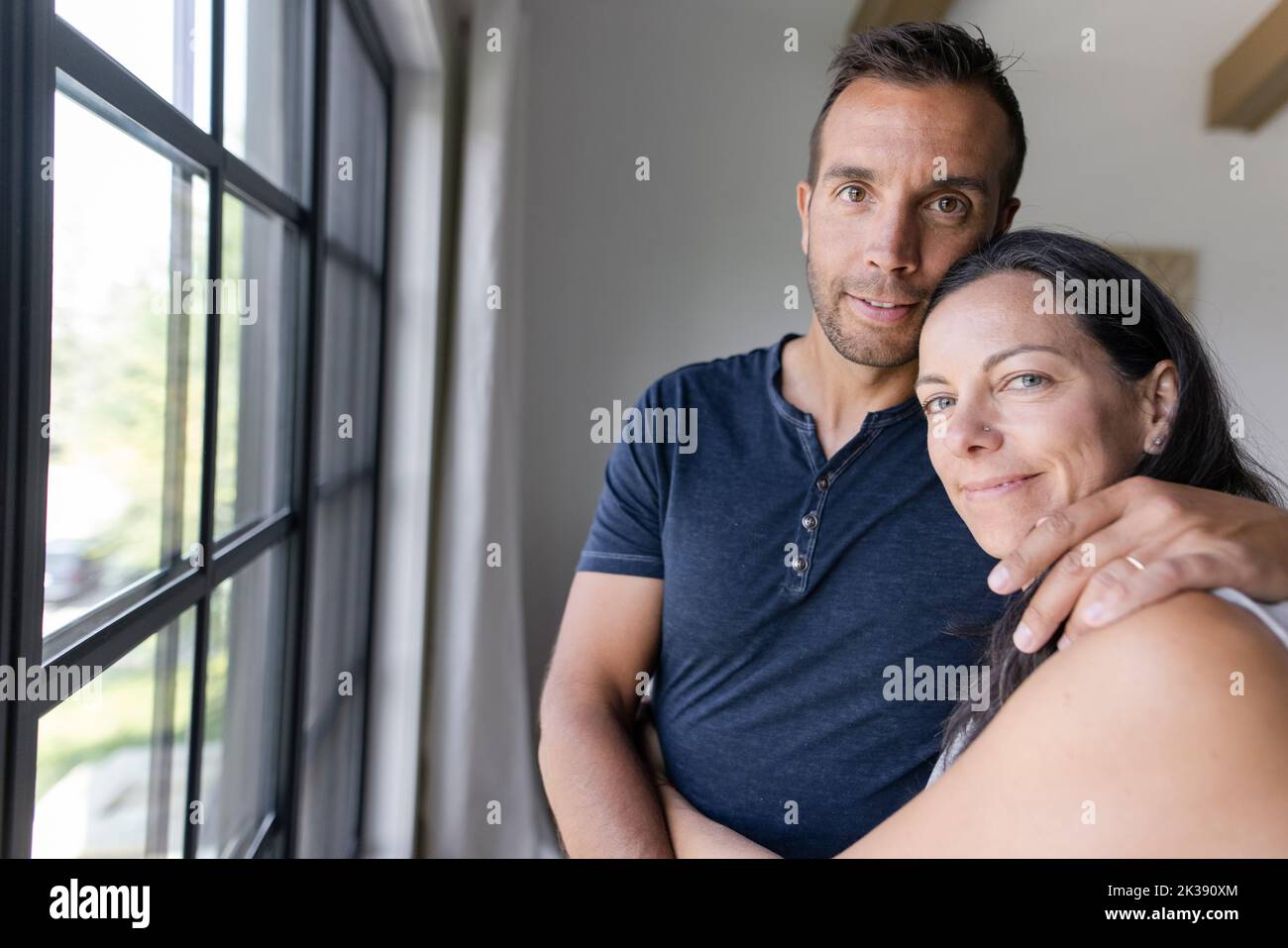 Portrait happy couple hugging Stock Photo - Alamy
