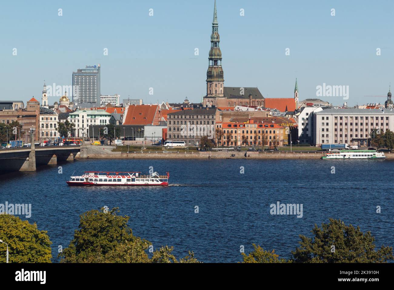 View of Daugava River, and Riga Old Town and St. Peter's Church Spire ...