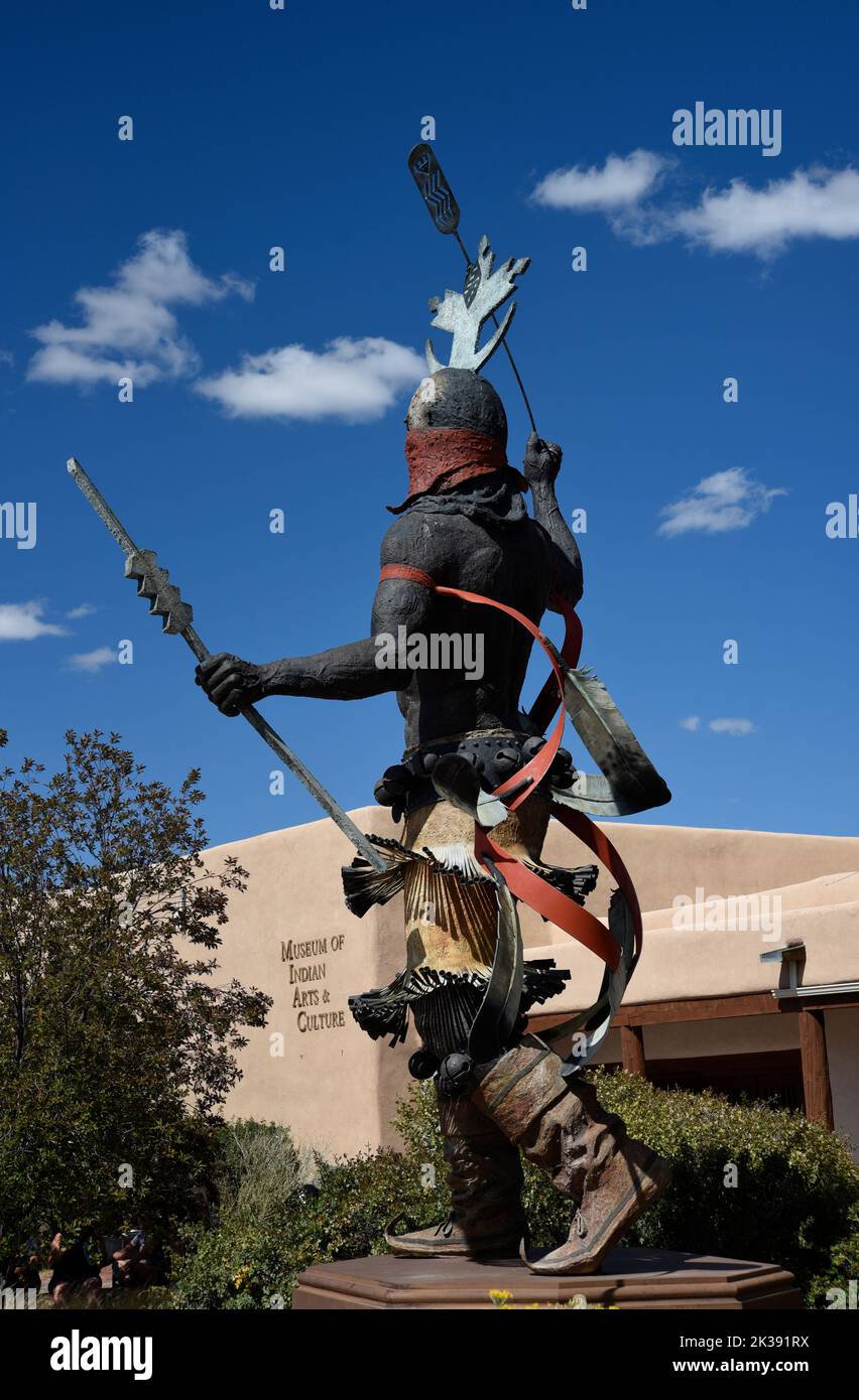 A bronze statue of an Apache Mountain Spirit Dancer in front of the ...