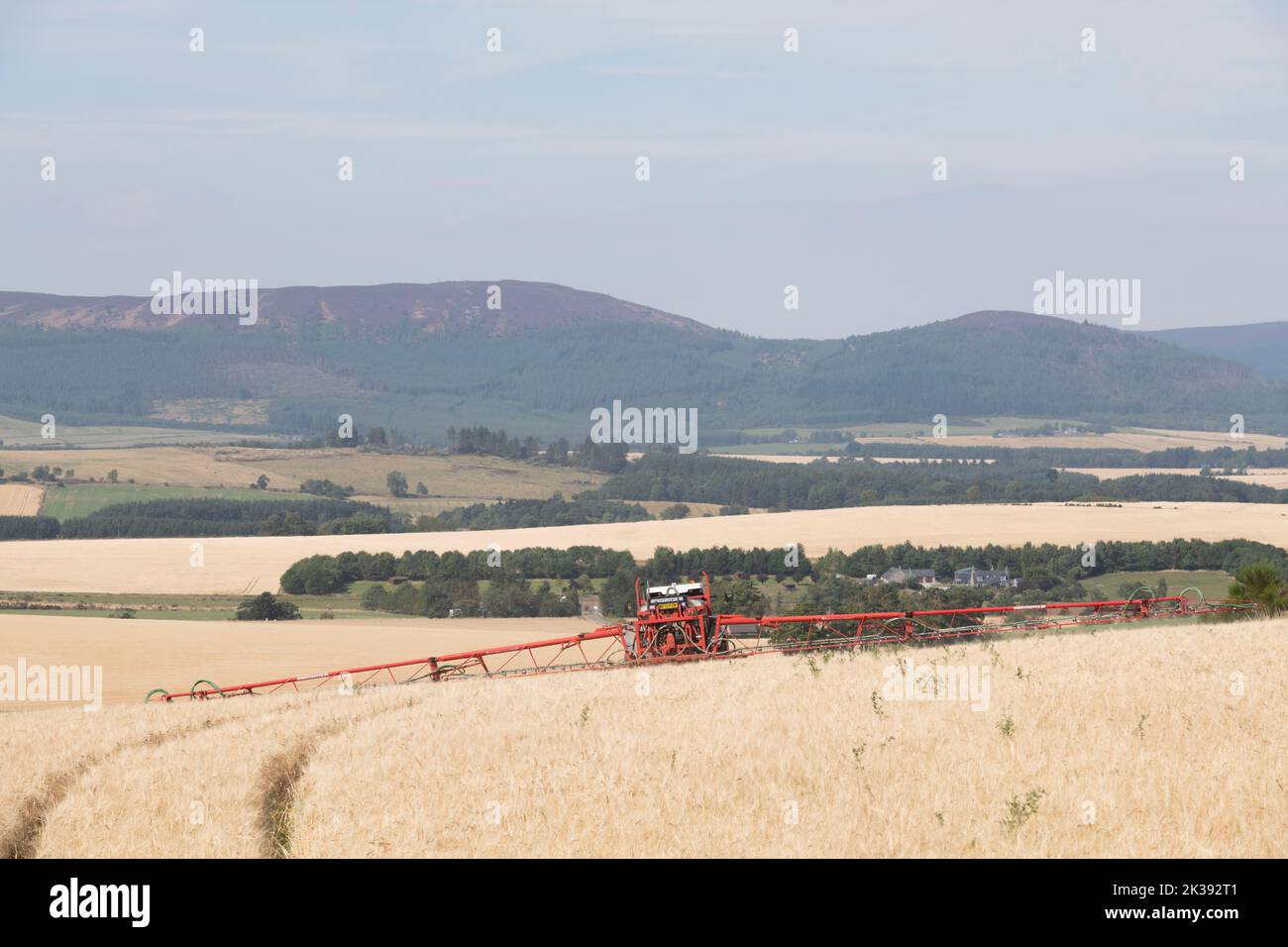 A View Over Aberdeenshire Farmland in Summer with a Red Crop Sprayer ...