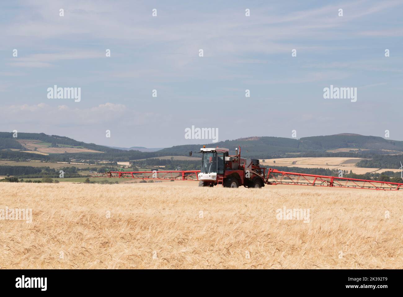A Crop Sprayer Operating in a Field of Barley Showing the Spray Boom ...