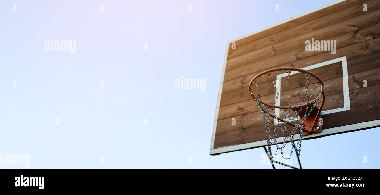 Banner basketball hoop, metal net and wooden backboard for game on blue ...