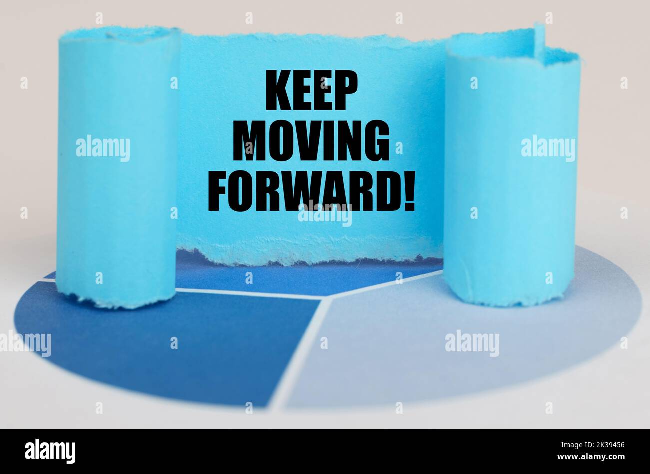 Business concept. On the blue diagram is a twisted paper sign with the ...