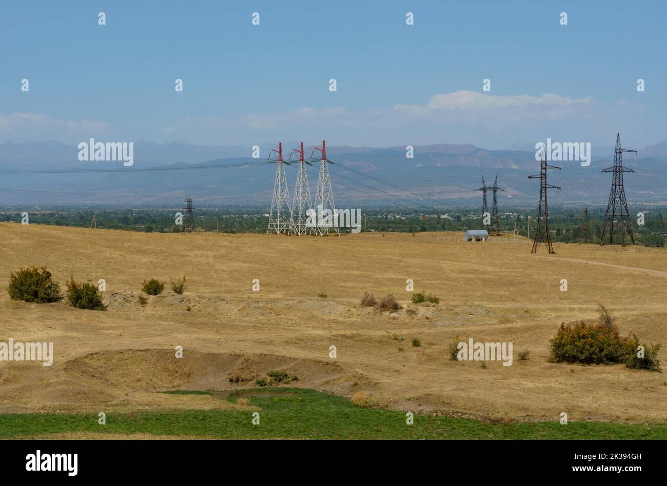 Power line in the valley along the forested mountains. Electrical ...