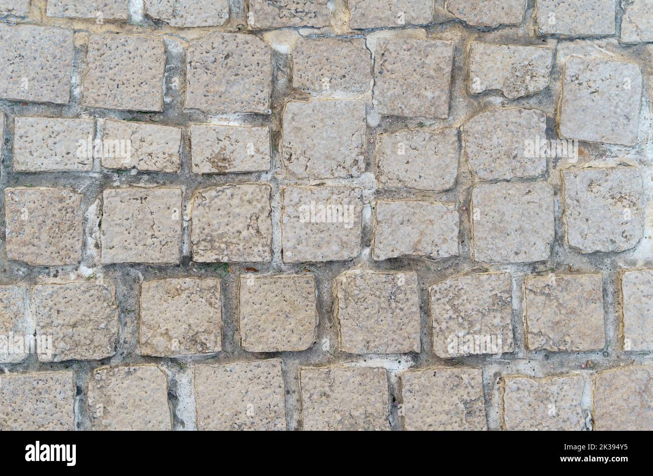 The texture of the stone pavement. Granite square cobblestone pavement ...