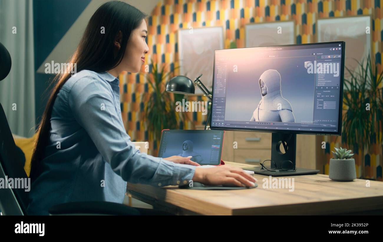 Asian woman creating 3D model of video game character in professional ... Asian woman creating 3D model of video game character in professional ...