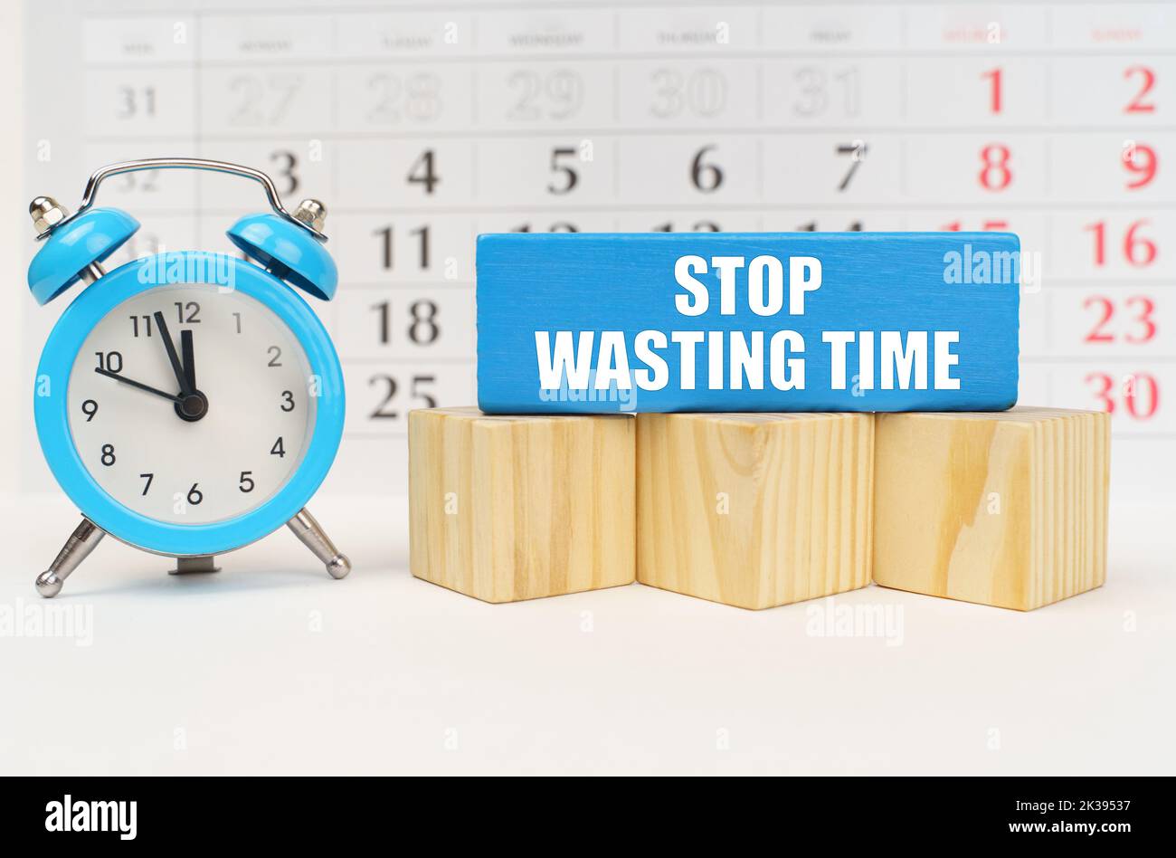 Time concept. Against the background of the calendar is an alarm clock ...